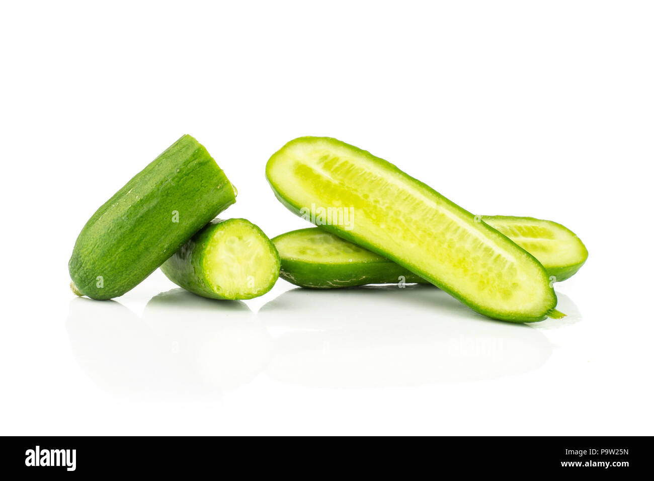 Sliced fresh green mini cucumbers halves isolated on white background ...