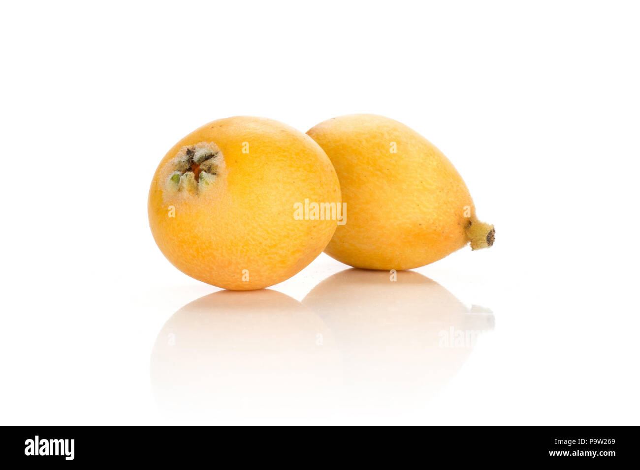 Two fresh Japanese loquats isolated on white background Stock Photo - Alamy