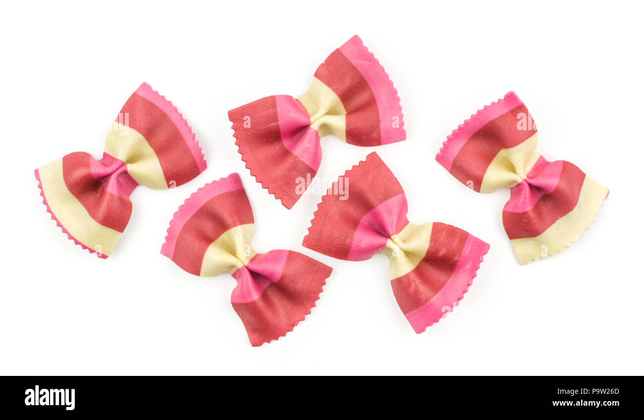 Farfalle pasta with red beet and paprika isolated on white background ...