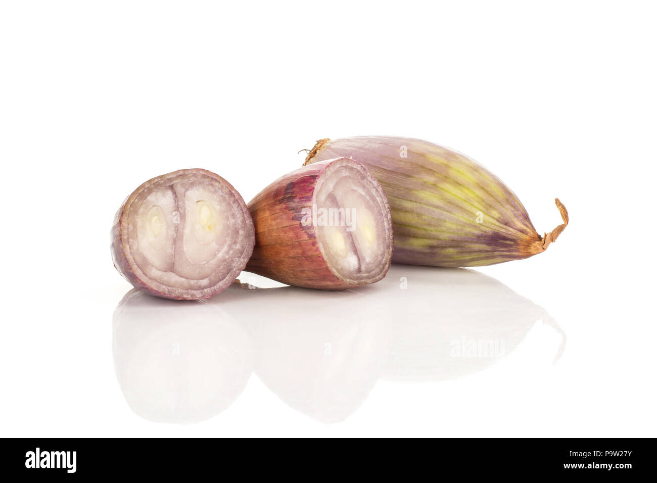Two shallot halves and one whole peeled isolated on white background ...