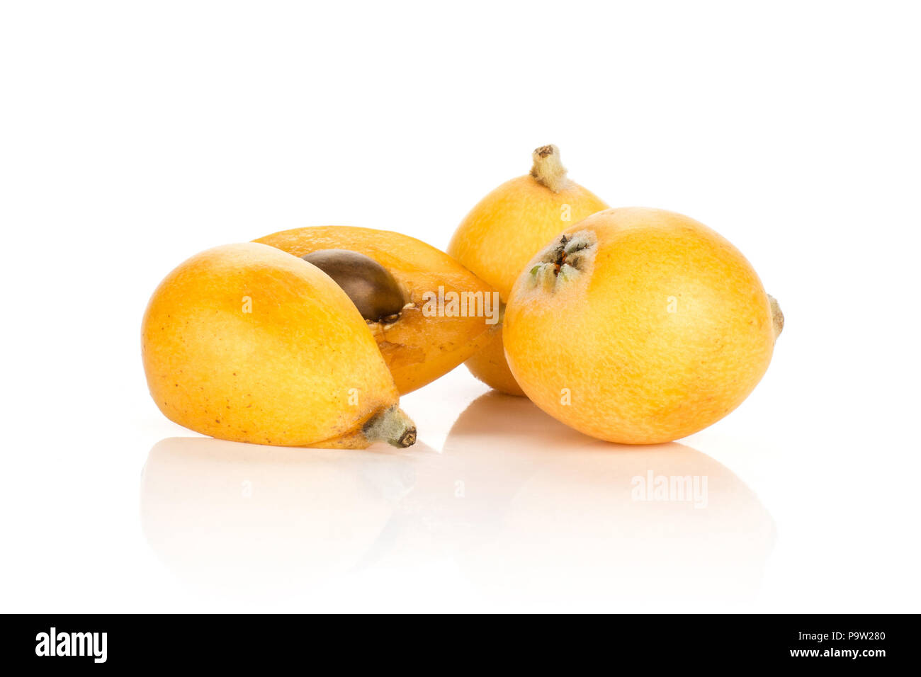 One sliced orange Japanese loquat and two whole isolated on white ...