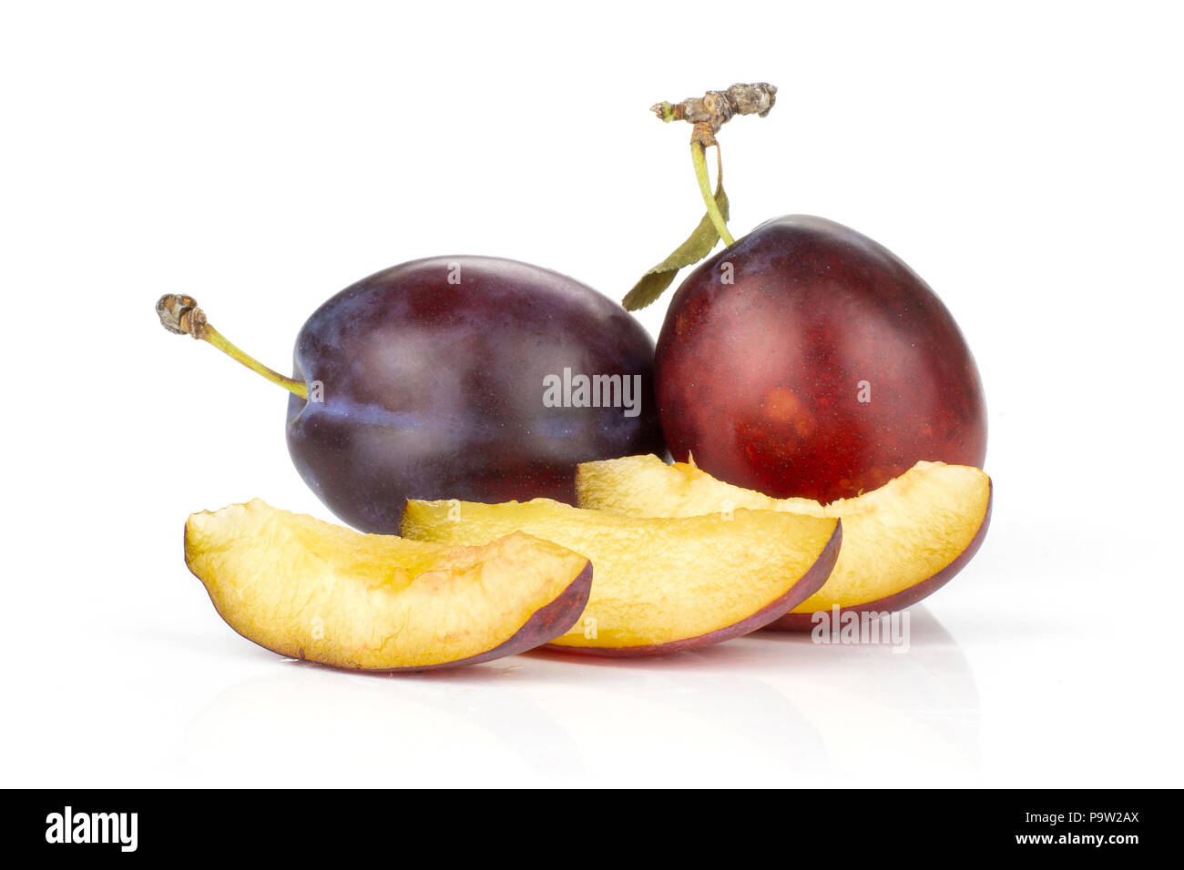 Group of two whole three slices of fresh violet-blue plum vibrant moyer ...