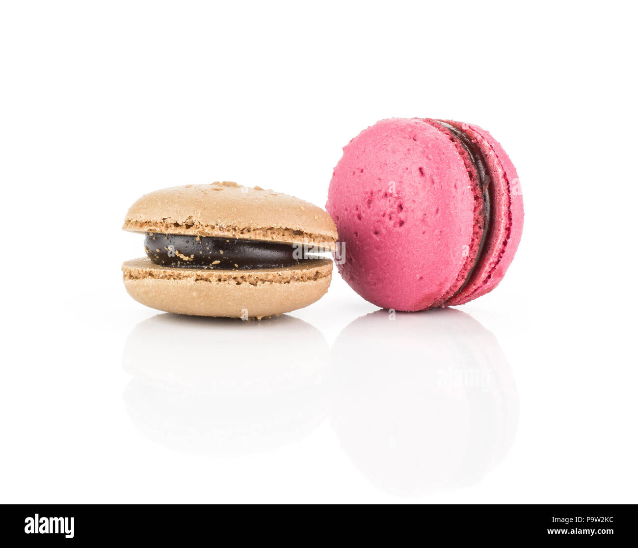 Two French macarons (chocolate, pink raspberry) isolated on white ...