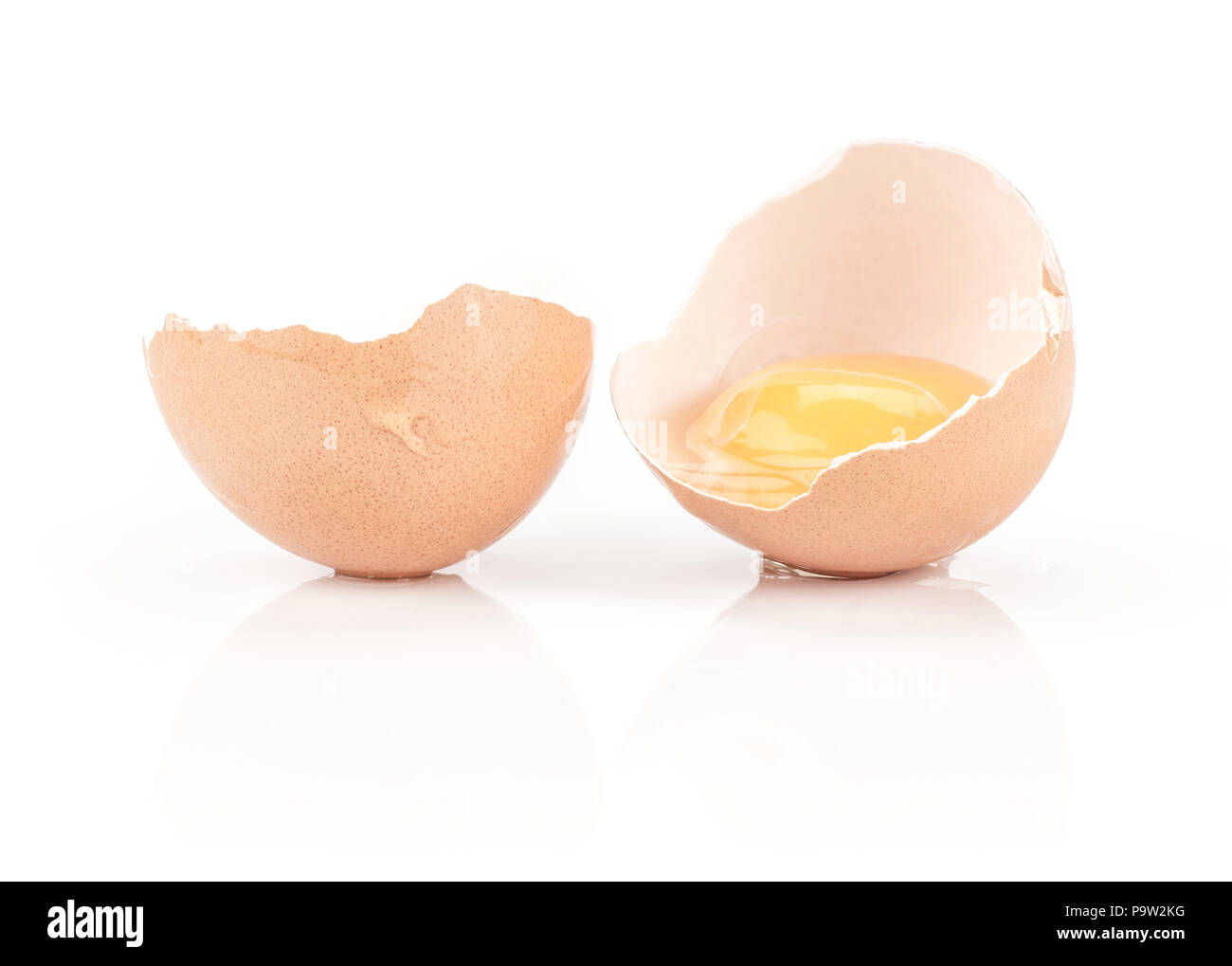 One cracked brown chicken egg isolated on white background raw yolk in ...
