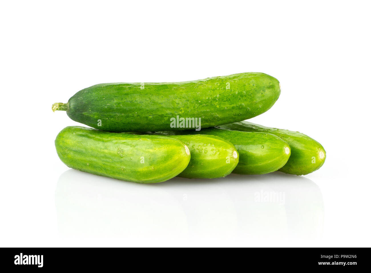 Five fresh green mini cucumbers isolated on white background Stock ...