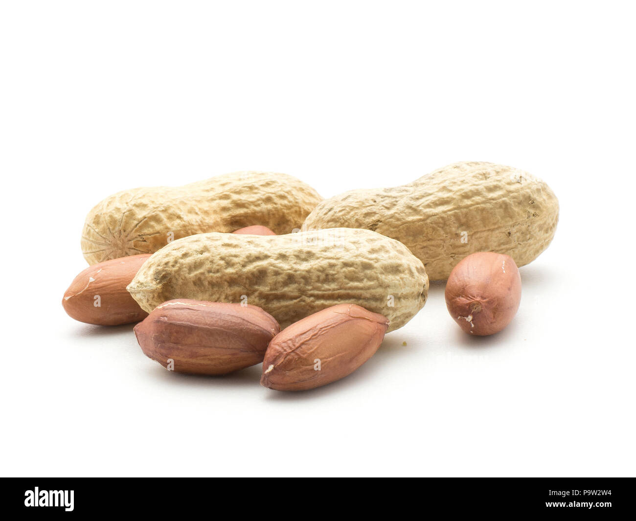 Four shelled peanuts in husk and three unshelled nuts isolated on white ...