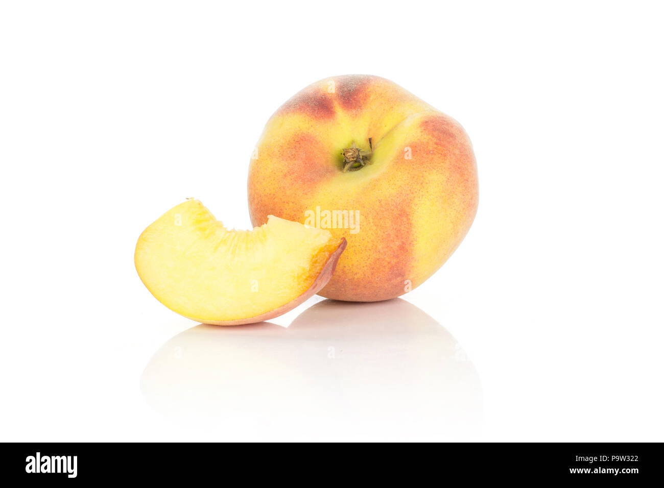 One yellow peach and a slice isolated on white background Stock Photo ...