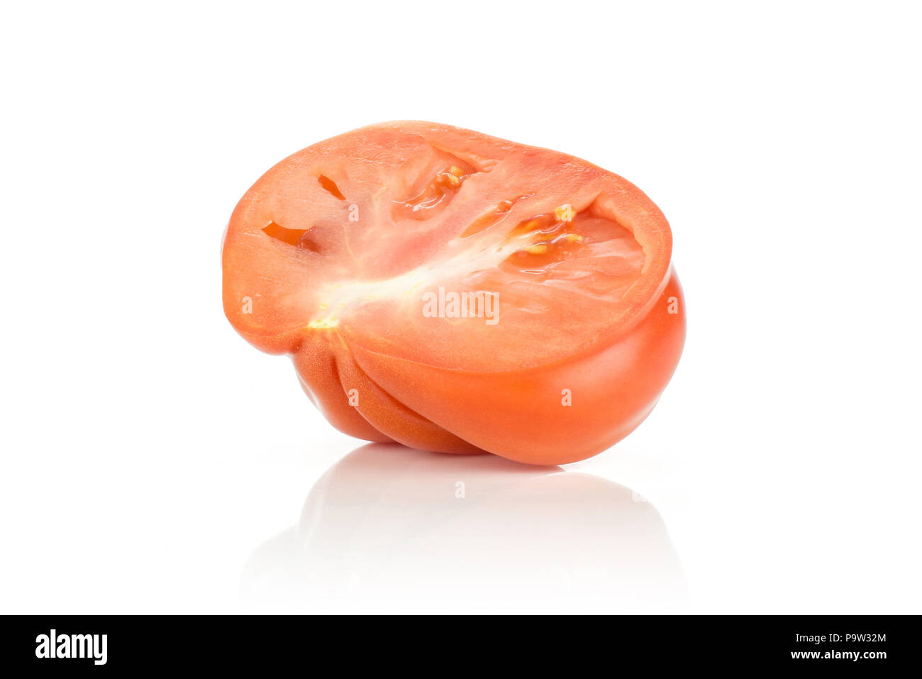 One beef tomato half isolated on white background big ripe red ribbing ...