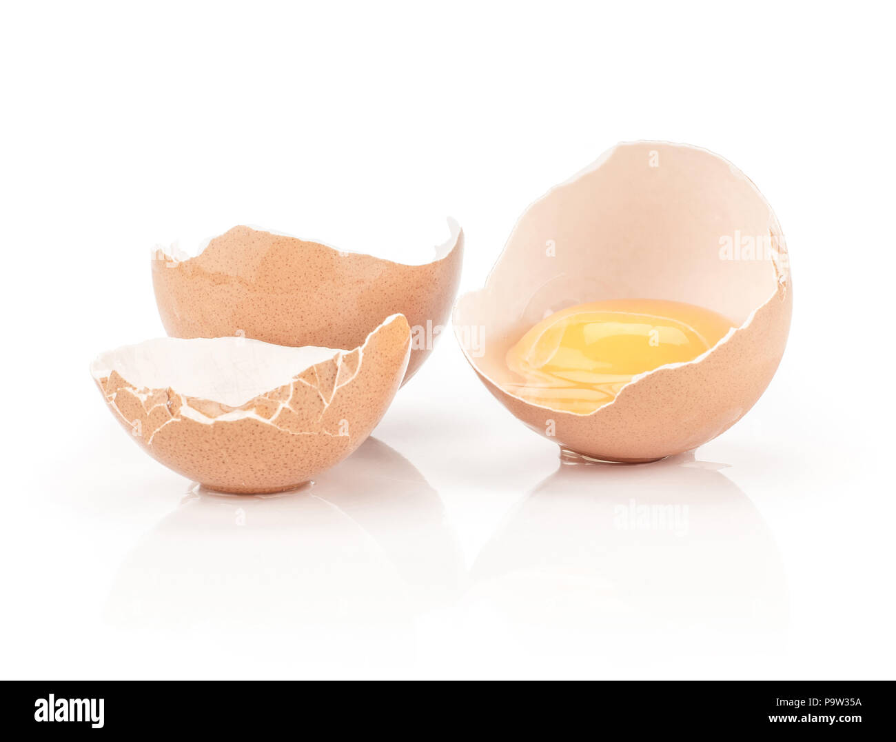 Cracked brown chicken egg isolated on white background raw yolk in one ...