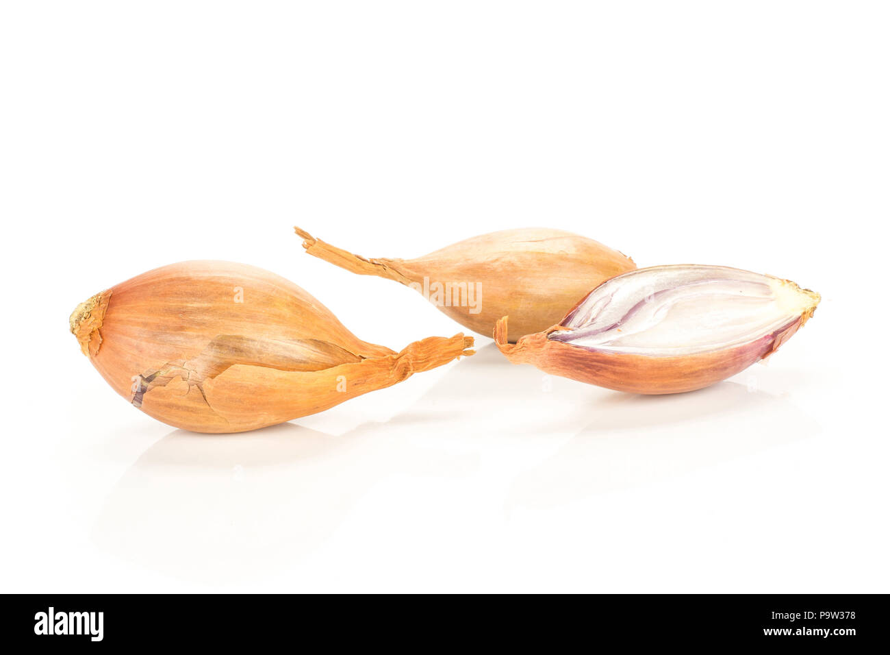 Two unpeeled shallots with one half isolated on white background Stock ...