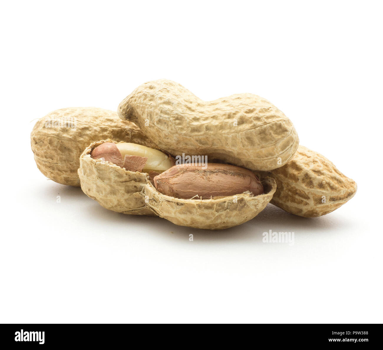 Three peanuts in husk one broken with two seeds inside isolated on ...