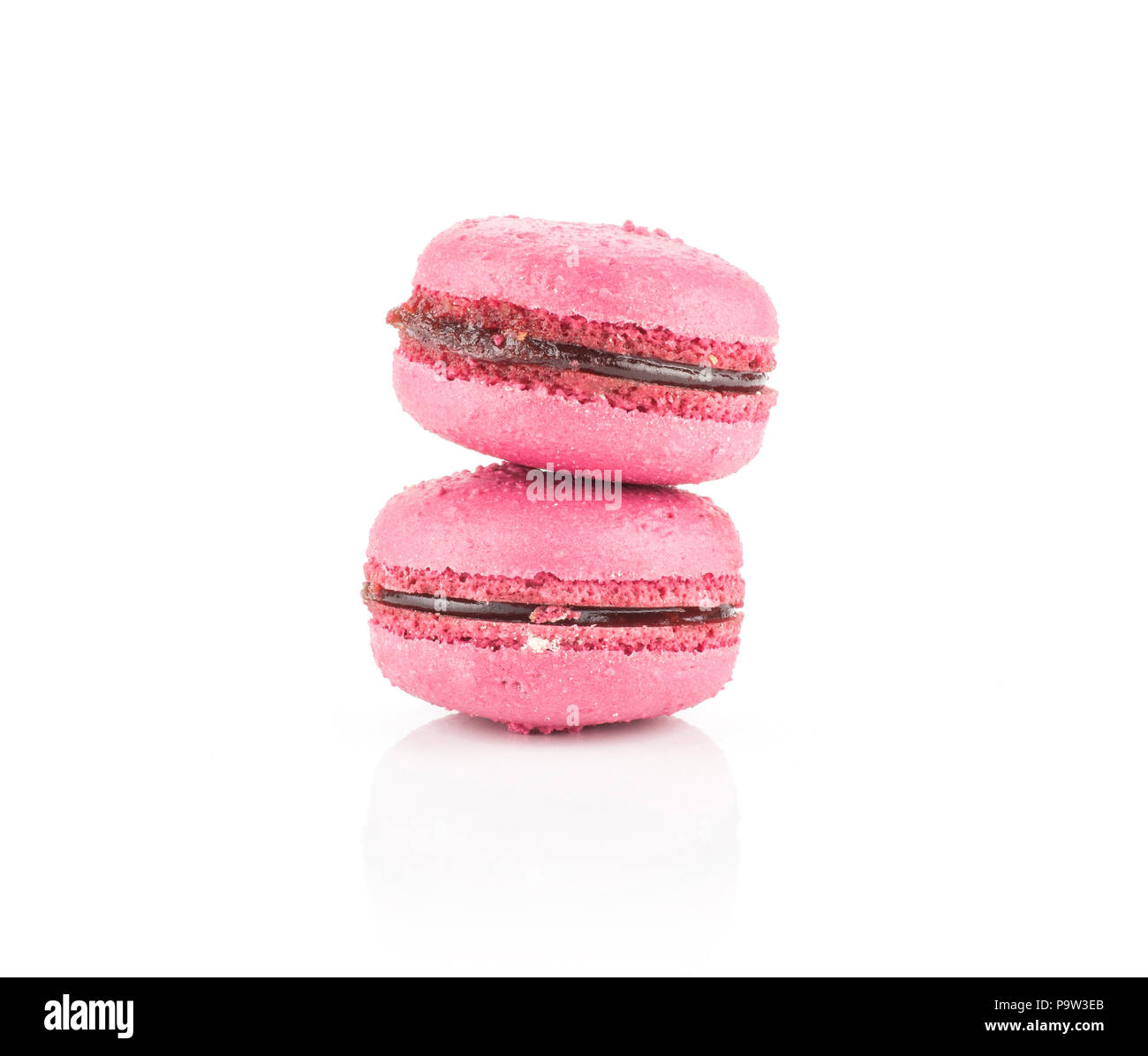 Two pink French macarons with raspberry jam isolated on white ...