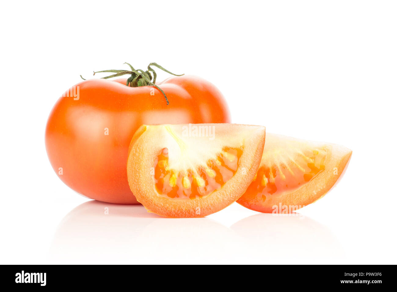 One red tomato with two slices isolated on white background Stock Photo ...