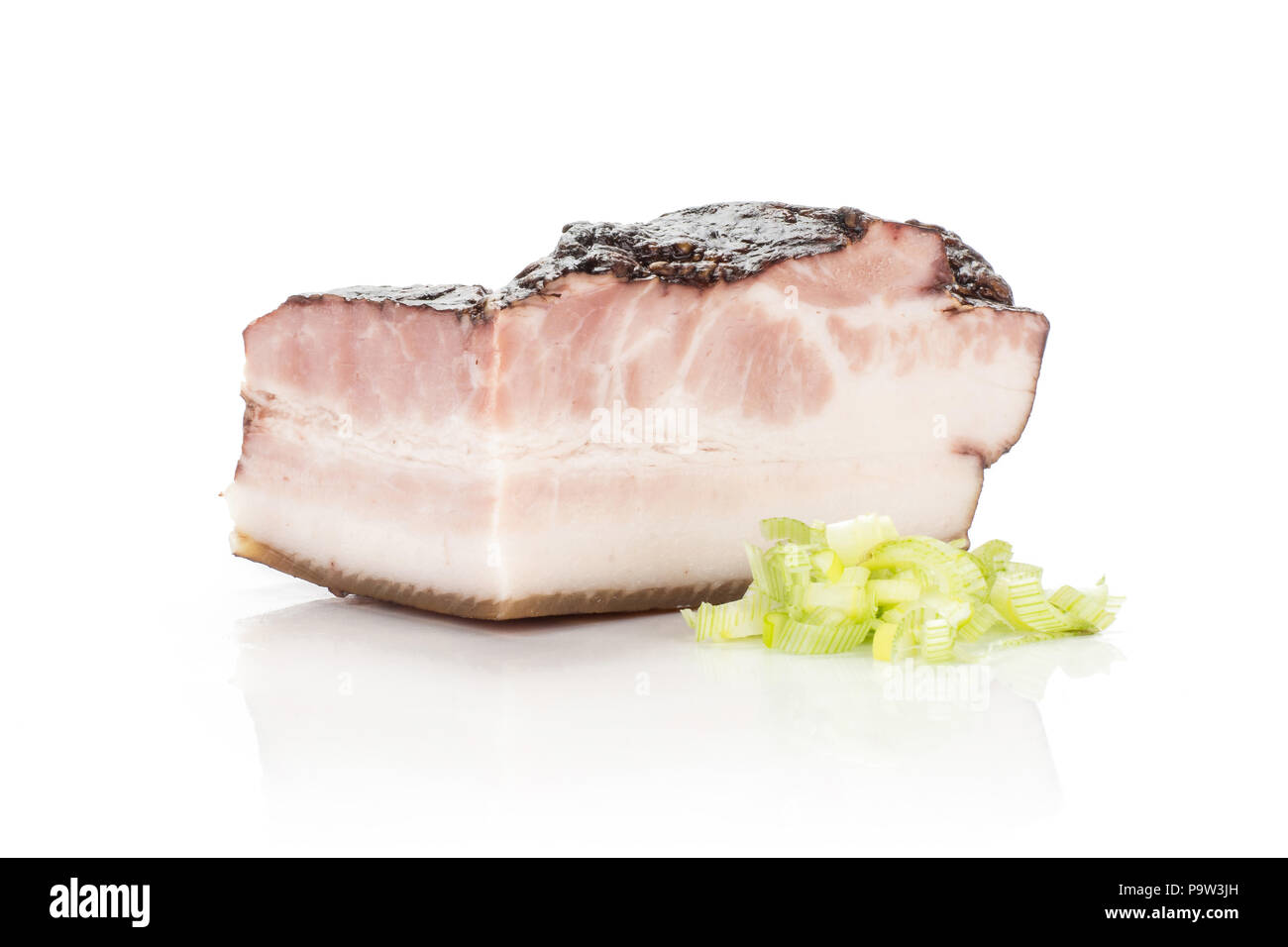 One piece of english bacon with fresh chopped spring onion isolated on ...