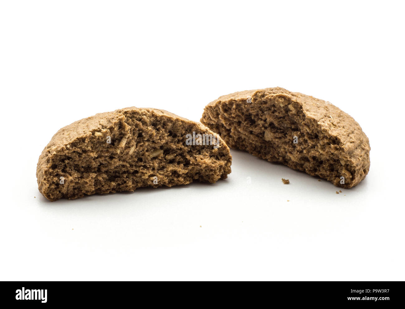 Cracked cocoa oat cookie two halves isolated on white background drop ...