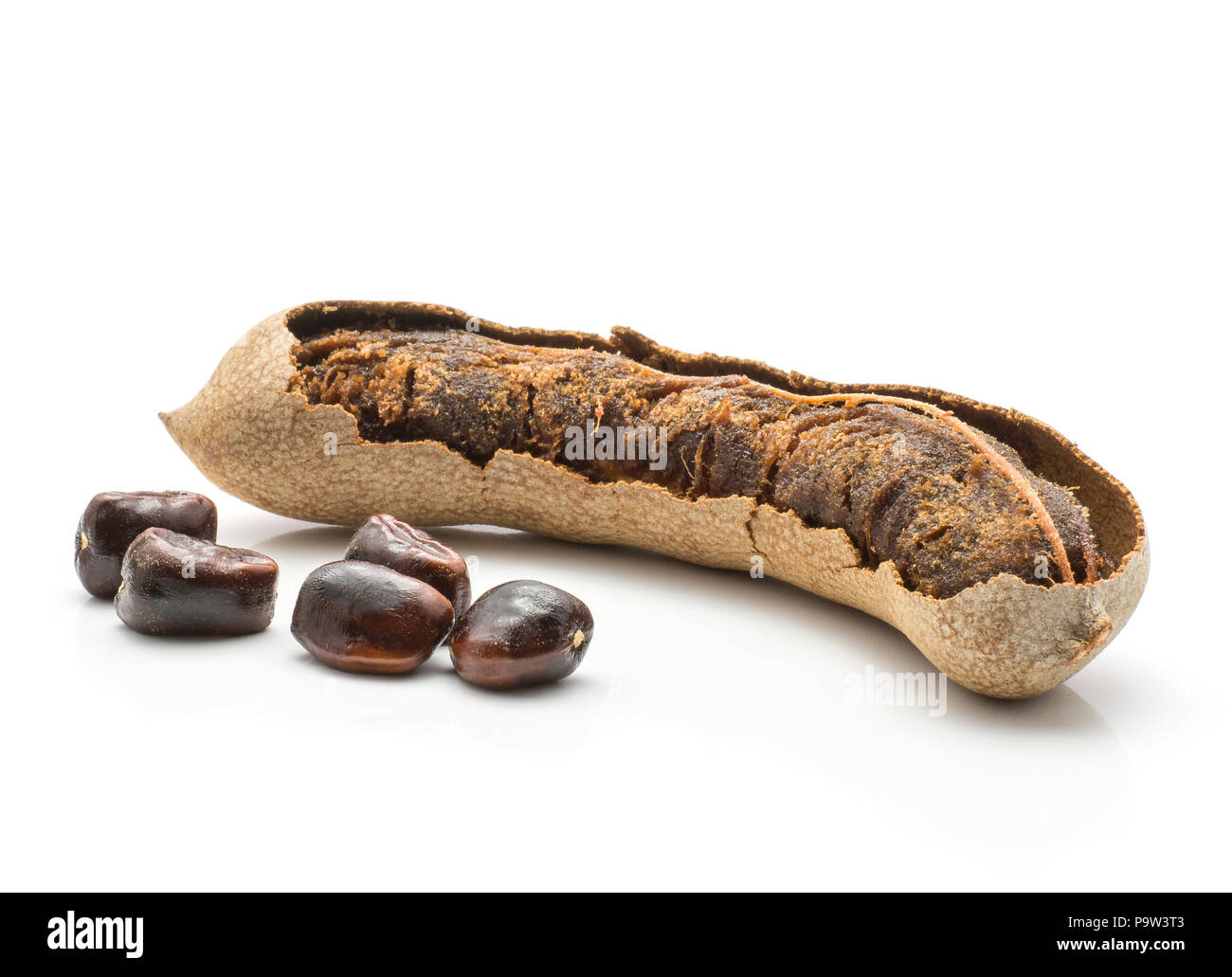 One open tamarind with glossy seeds isolated on white background Indian ...