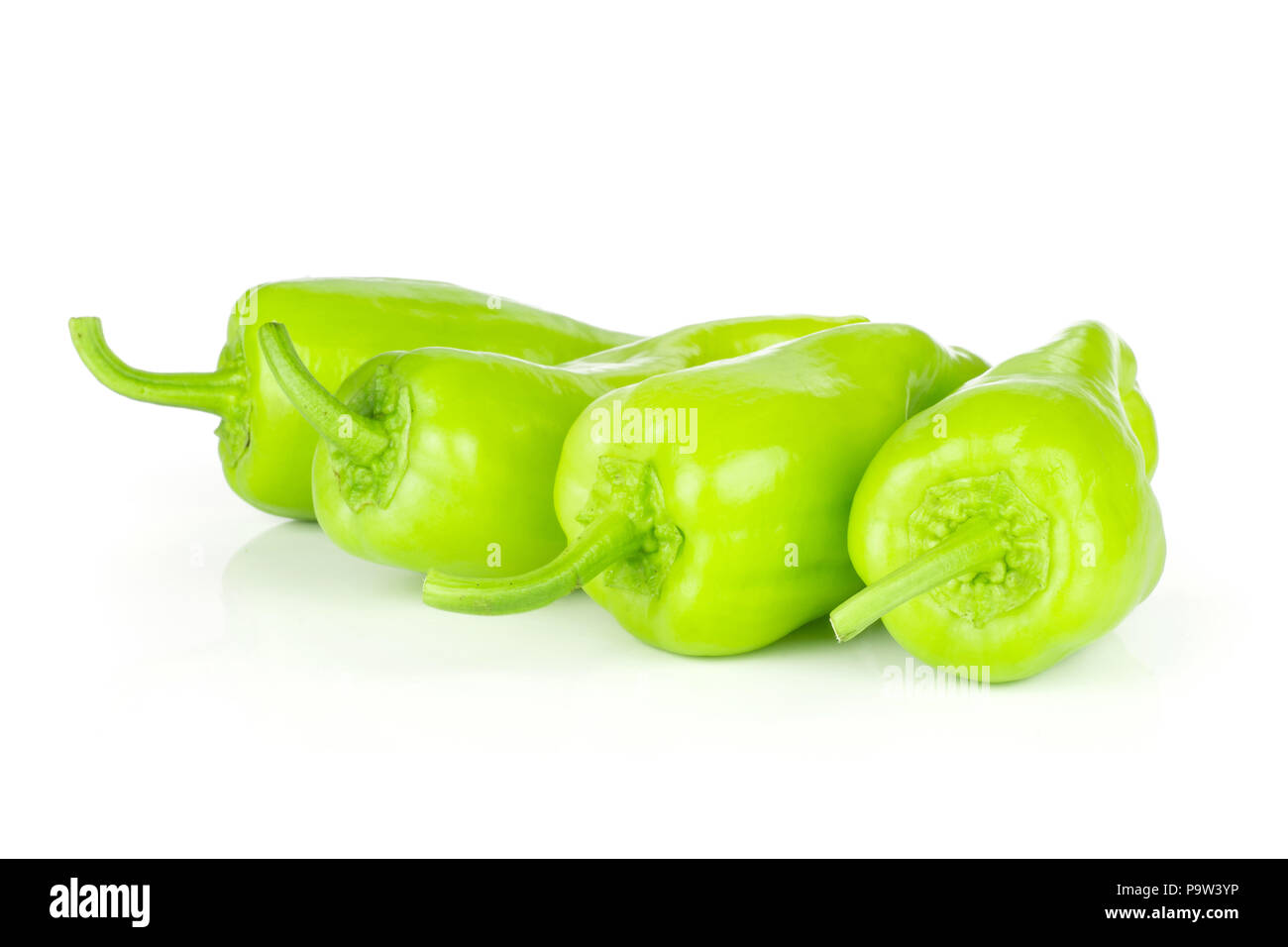 Group of three whole light green bell pepper in row isolated on white ...