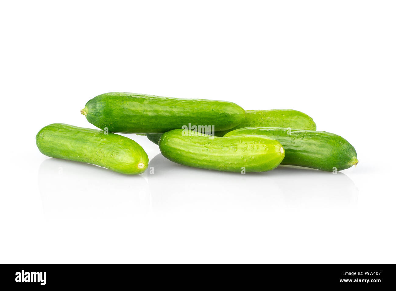 Five fresh green mini cucumbers isolated on white background Stock ...