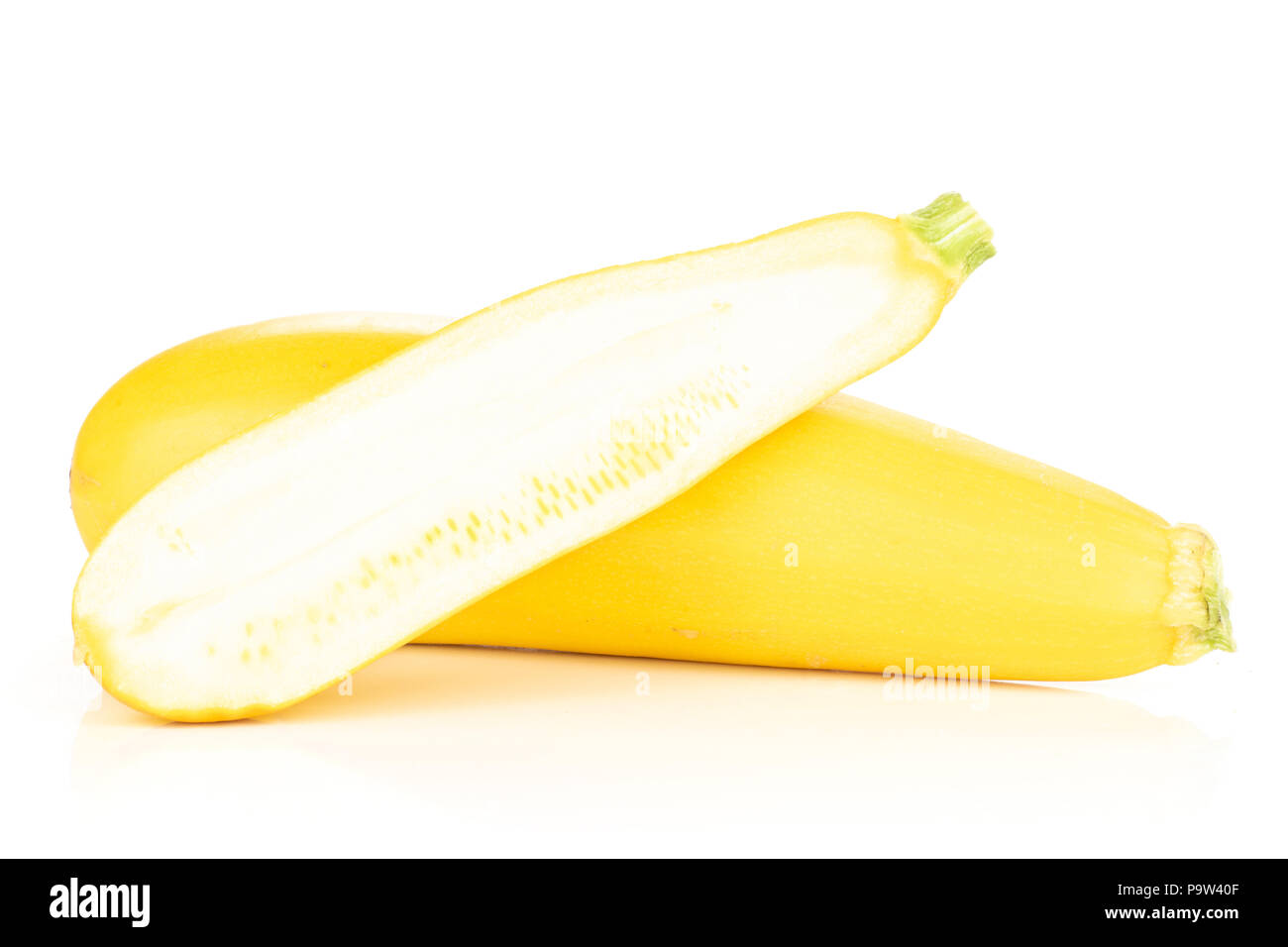 Group of one whole one half of raw yellow zucchini isolated on white ...
