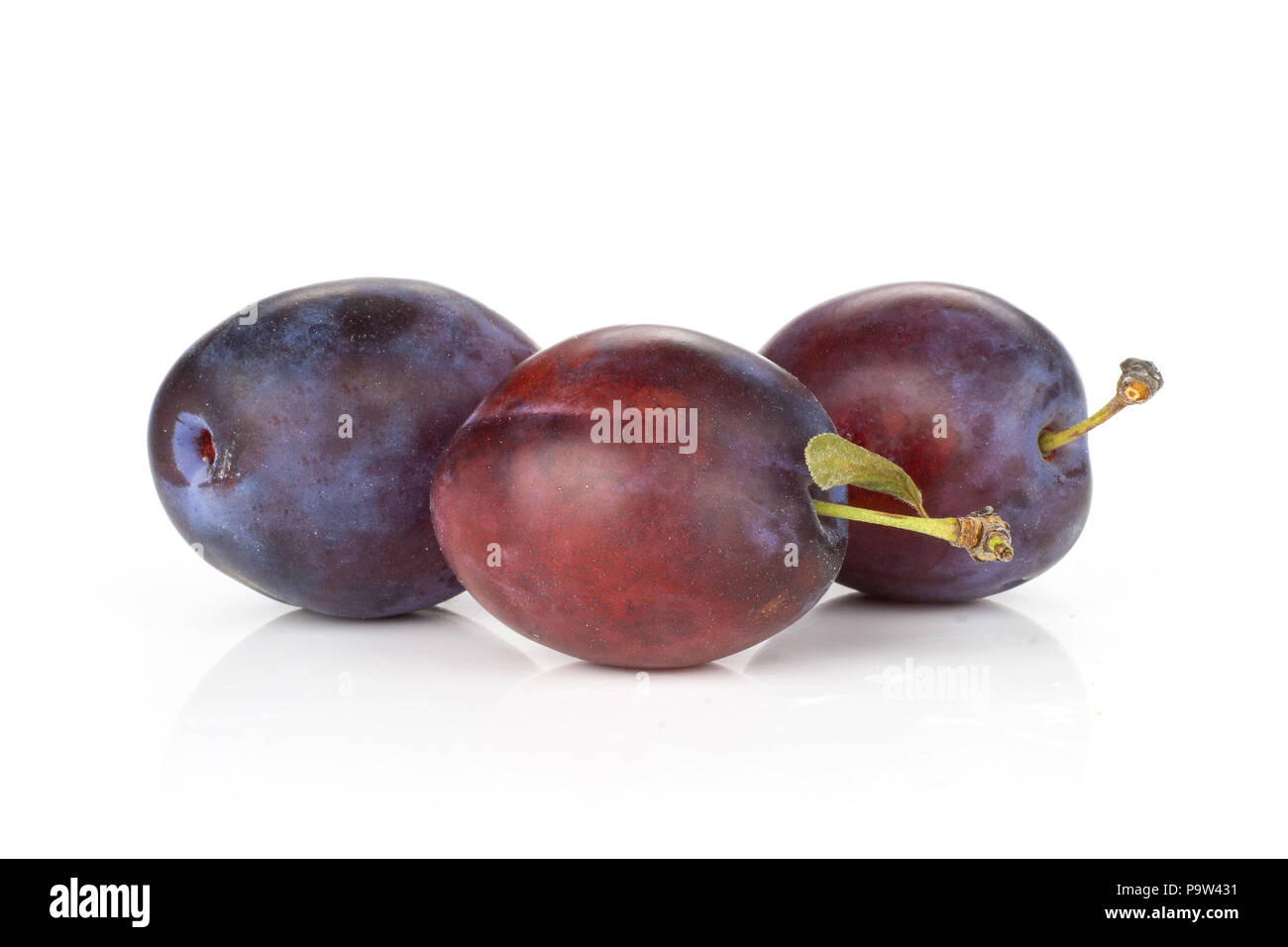 Group of three whole fresh violet-blue plum vibrant moyer variety stack ...