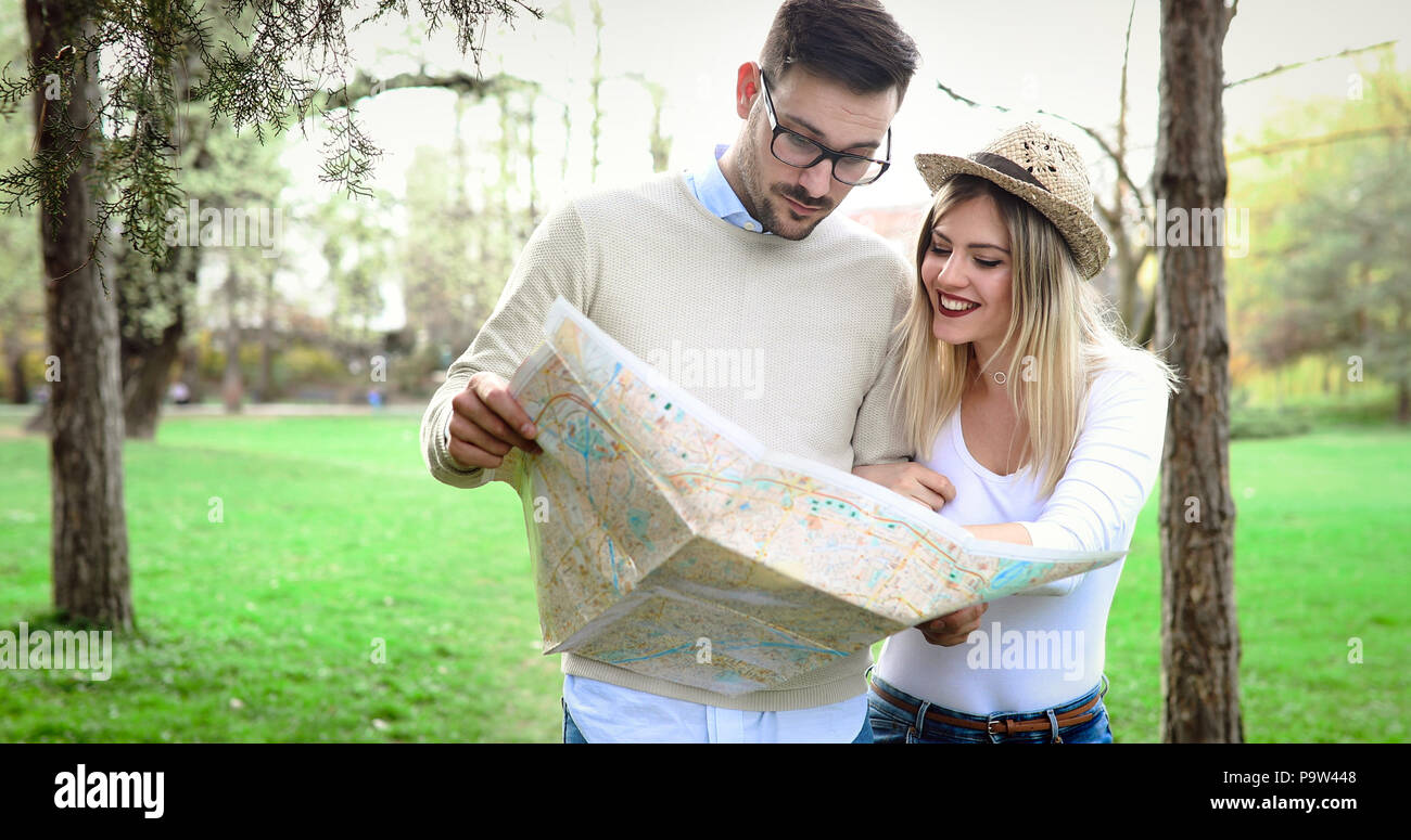 Tourist couple using map as guide Stock Photo - Alamy