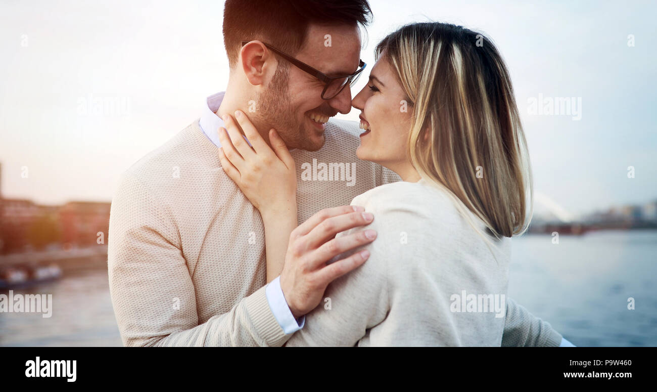 Happy couple in love hugging outdoor Stock Photo - Alamy