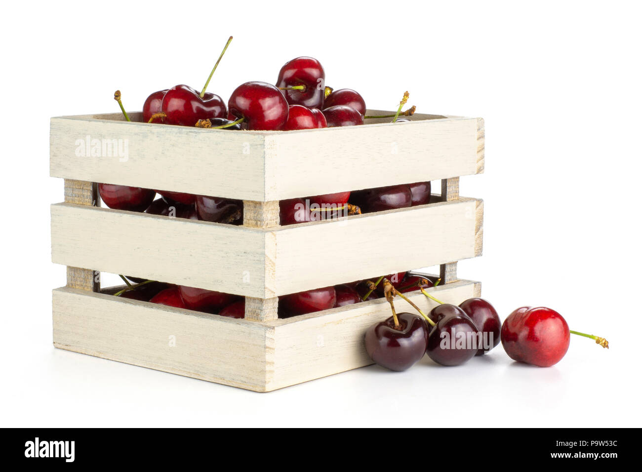 Sweet bright red cherry in a wooden box isolated on white Stock Photo ...