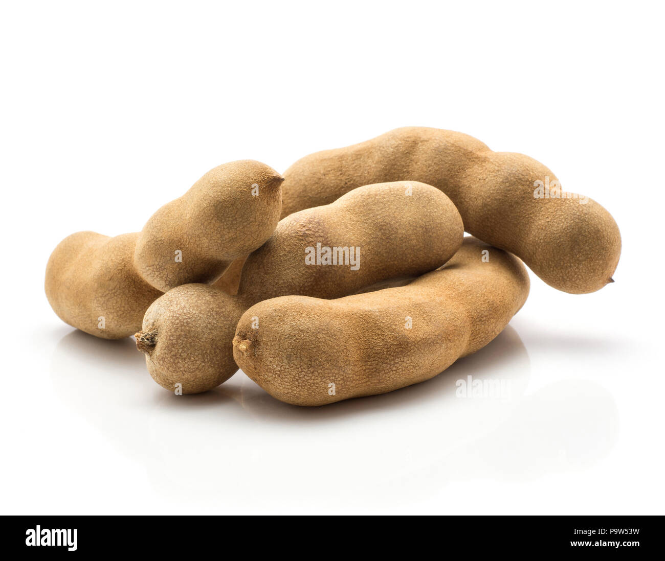 Tamarind four Indian dates in a brown brittle shell isolated on white ...