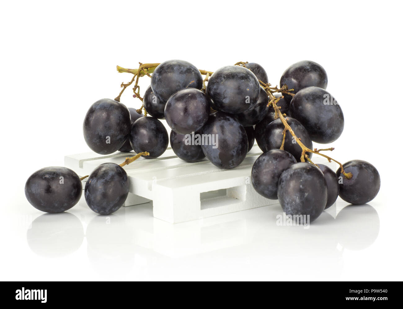 Black purple grape cluster (autumn royal variety) on a wooden pallet ...