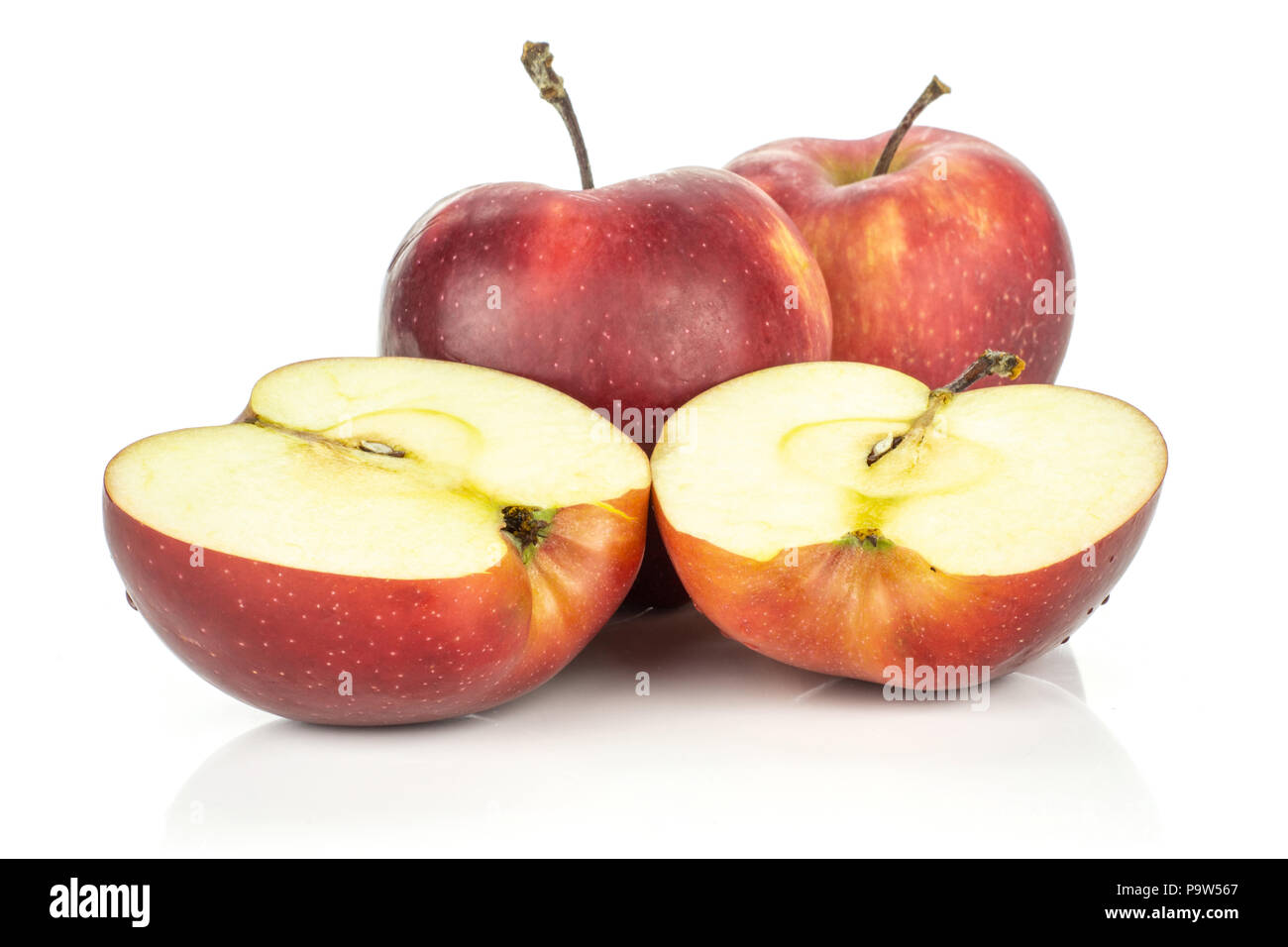 Two red delicious apples and two halves isolated on white background ...