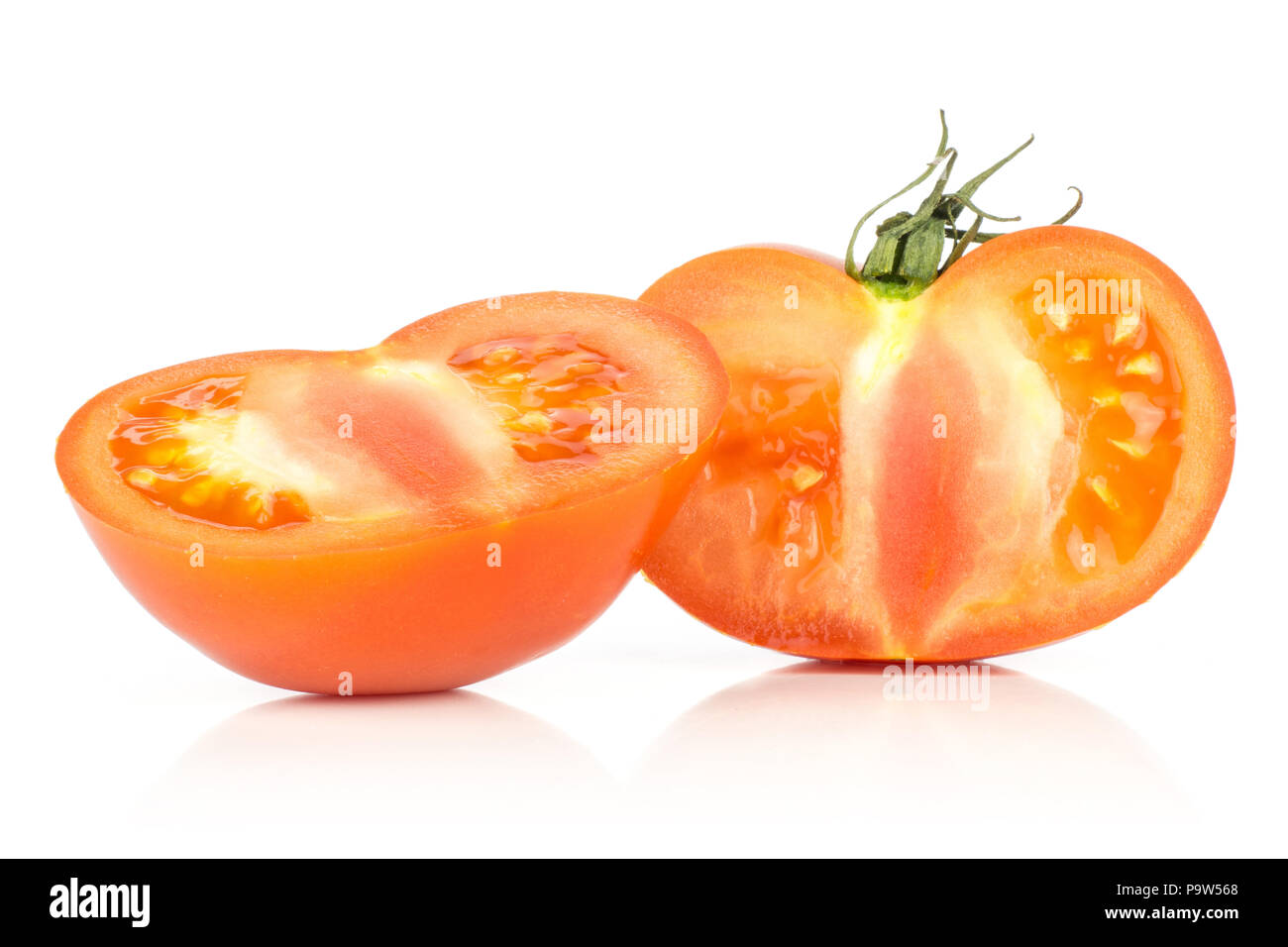 One red tomato cut in two section halves isolated on white background ...