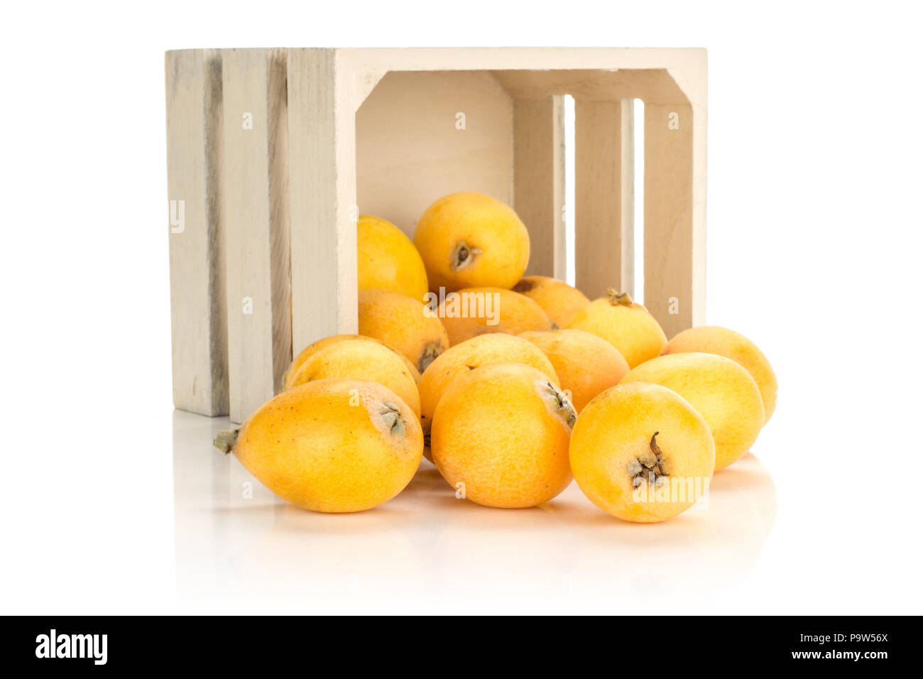 Fresh orange Japanese loquats out a wooden box isolated on white ...