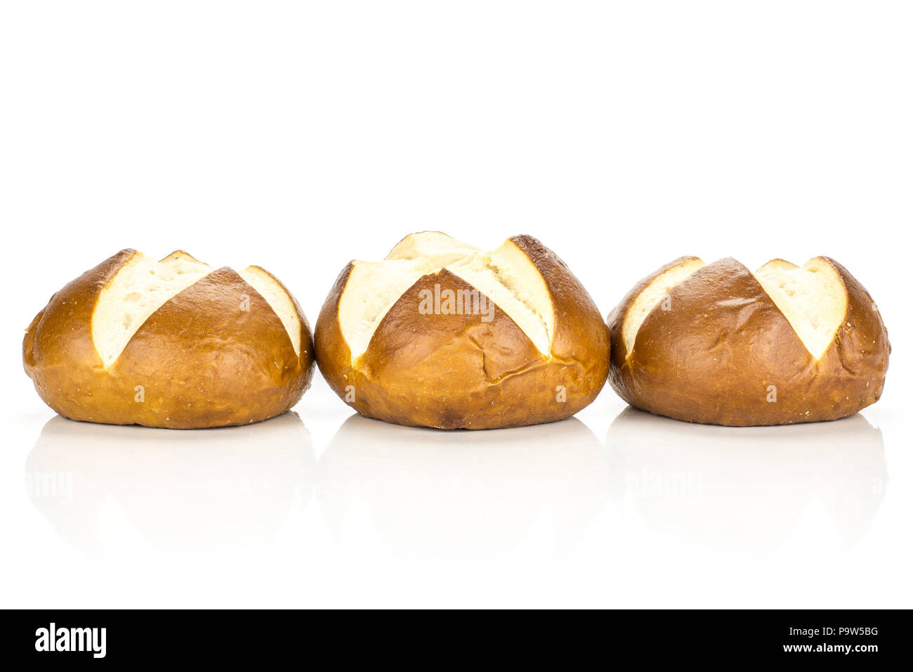 Fresh Bavarian bread buns in row isolated on white background three ...