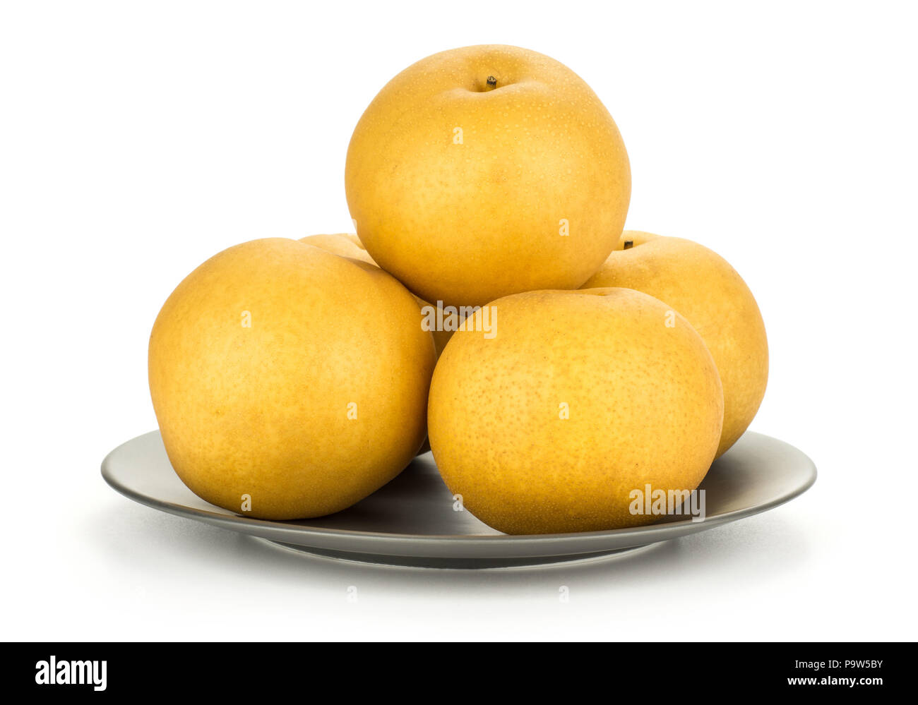 Chinese golden pears on a grey plate Nashi variety isolated on white ...