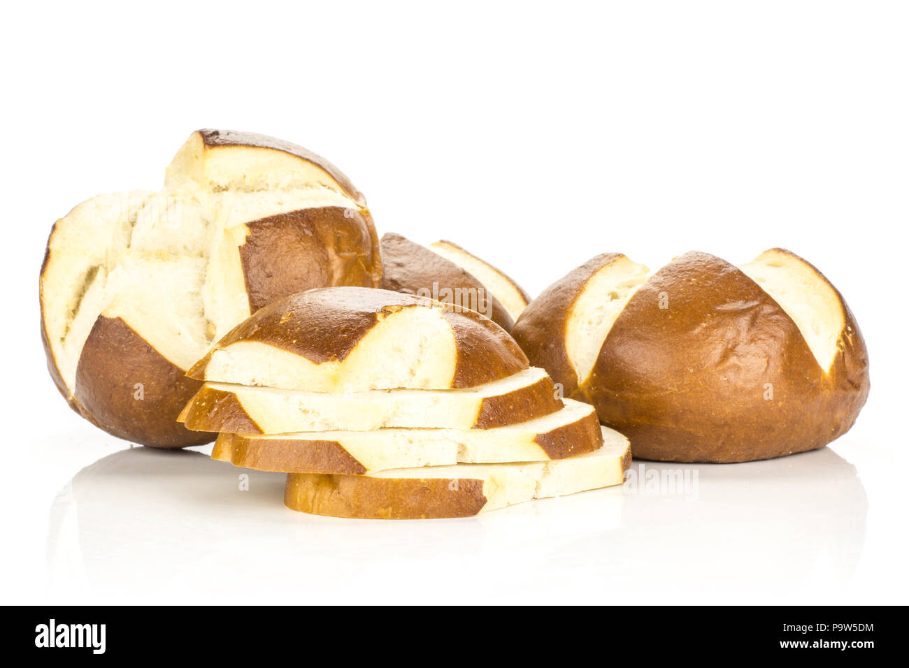 Three Bavarian bread buns and four sliced pieces isolated on white ...