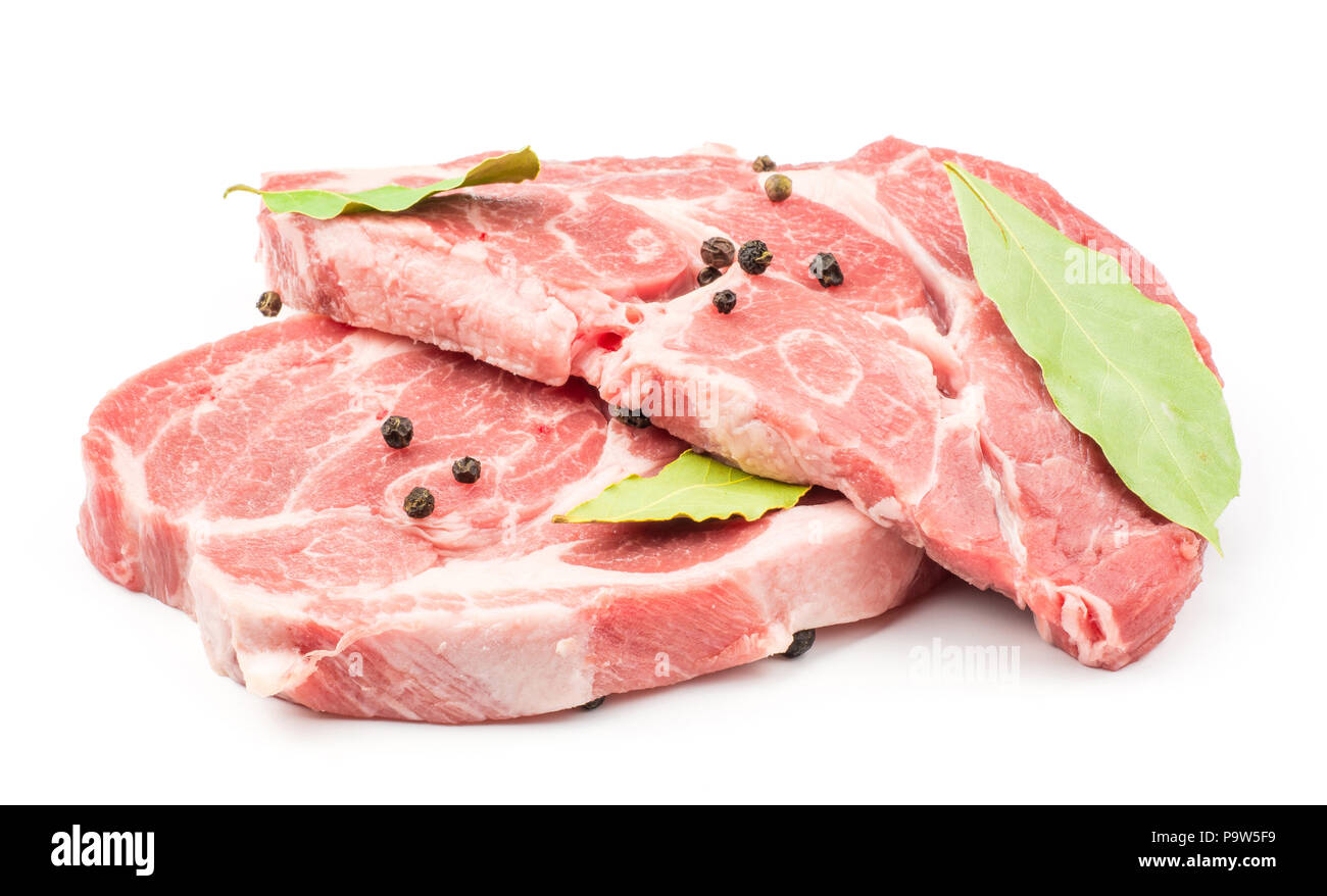 Raw pork neck meat cuts with black pepper and bay leaves isolated on ...