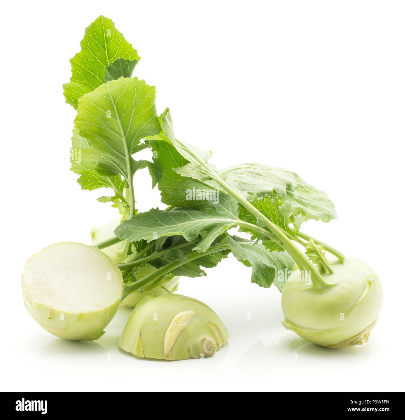 Two kohlrabi (German turnip or turnip cabbage) halves and one bulb with ...