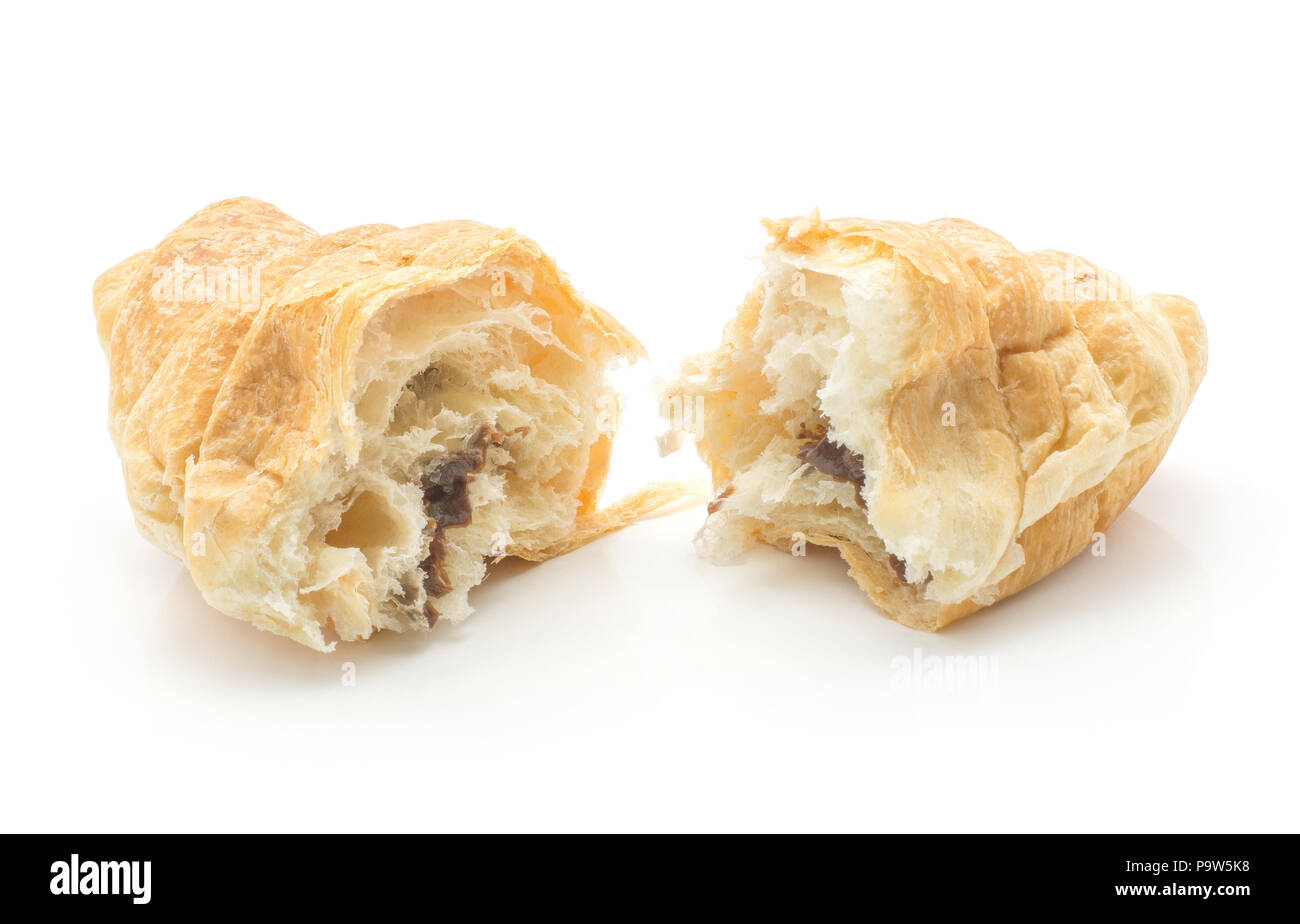Broken baked croissant or cornetto isolated on white background two ...