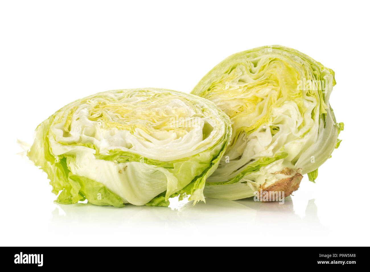 Iceberg lettuce one fresh cabbage head cut in two halves isolated on ...