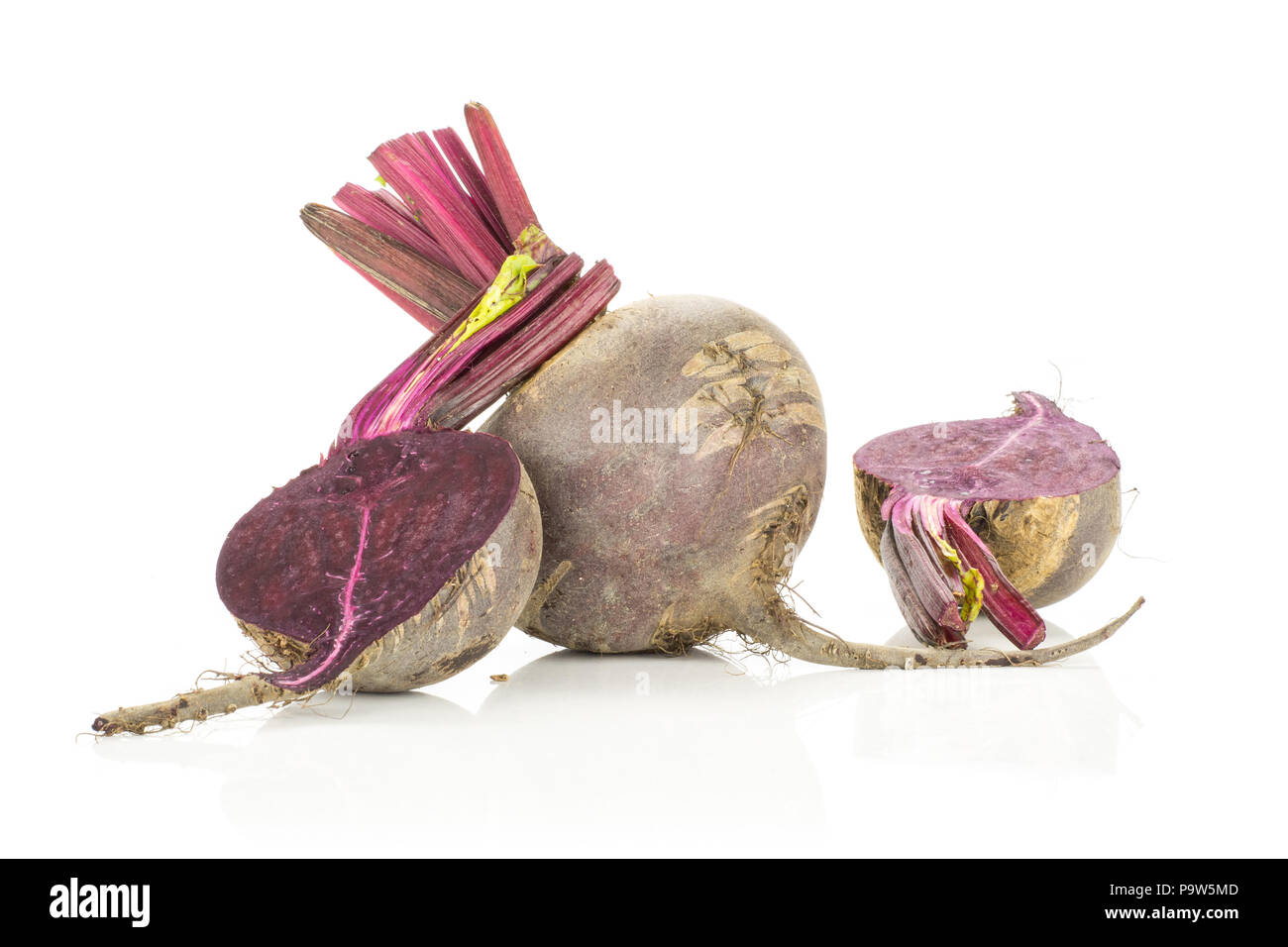 One red beet with two halves young bulbs isolated on white background ...