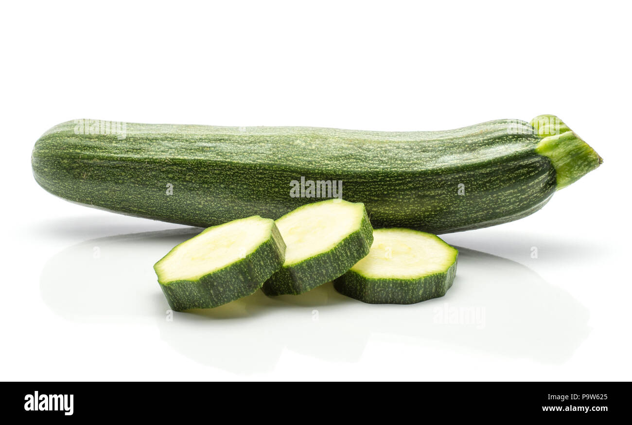 One green zucchini and three round slices isolated on white background ...