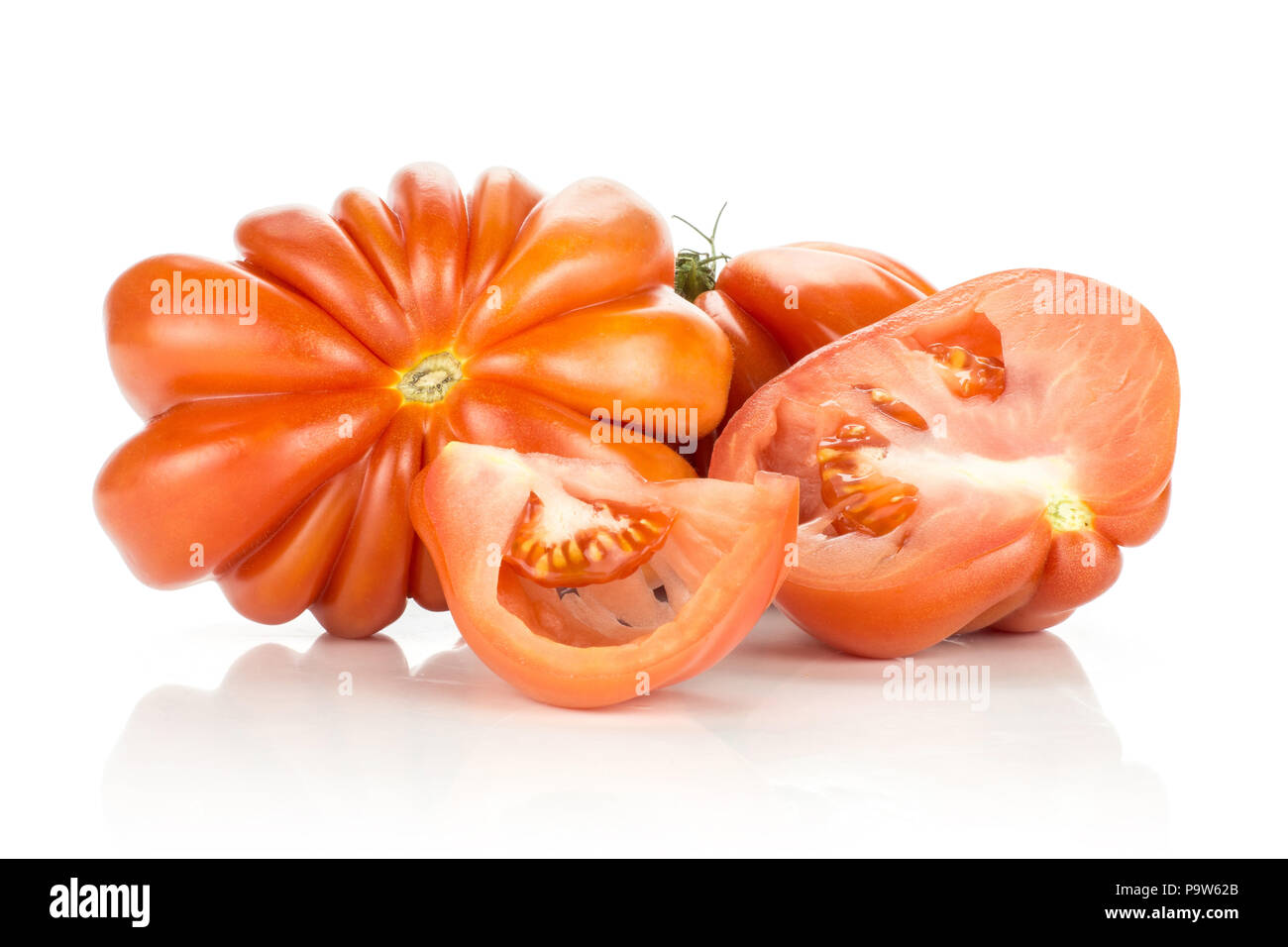 Sliced beef tomatoes set (two whole one flower shape section half and a ...