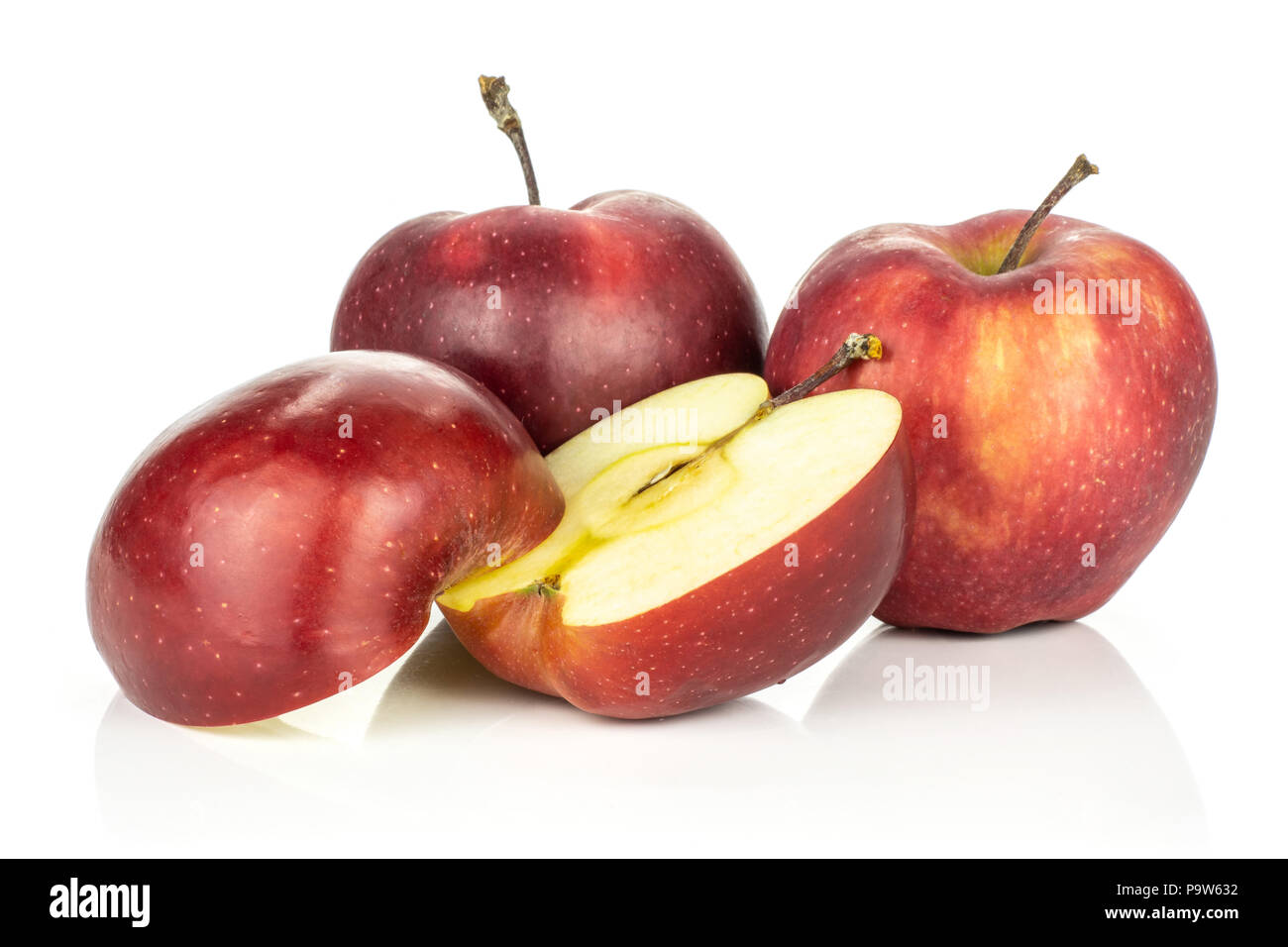 Two red delicious apples and one sliced in two halves isolated on white ...