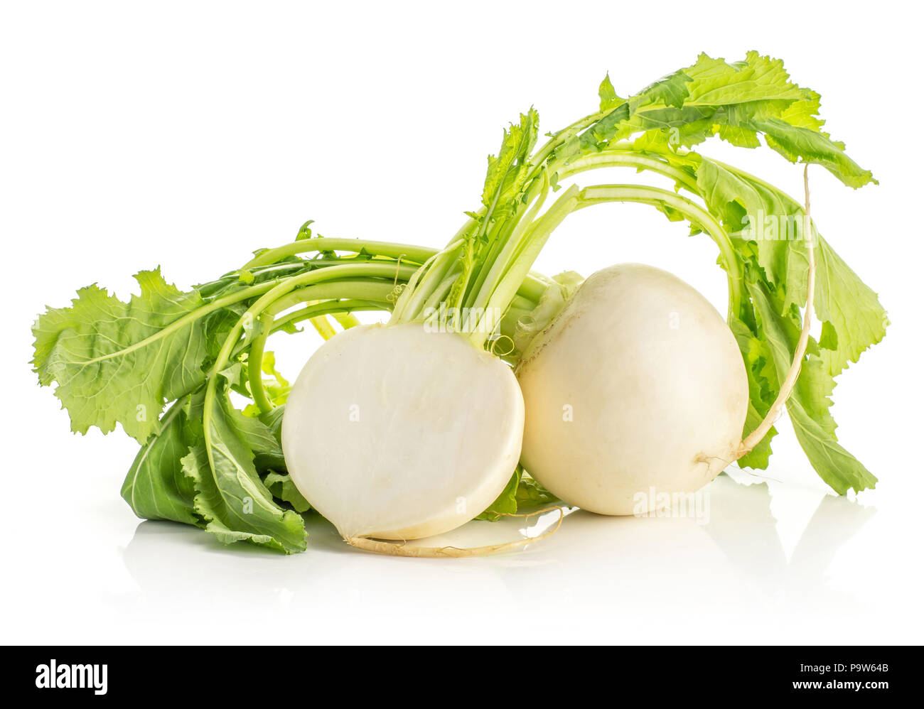 White radish bulb with fresh leaves and one section half isolated on ...