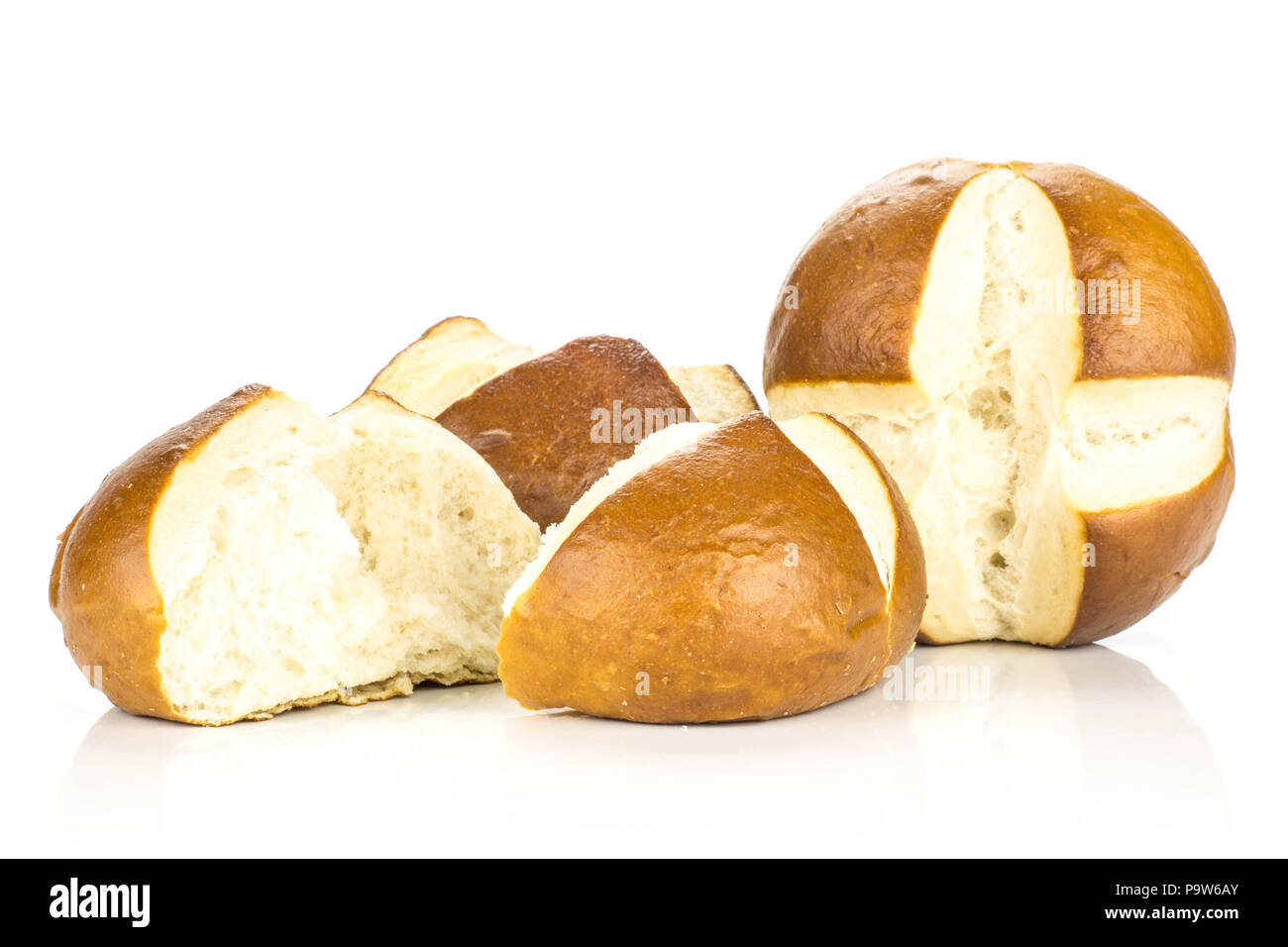 Two Bavarian bread buns and one broken in two halves isolated on white ...