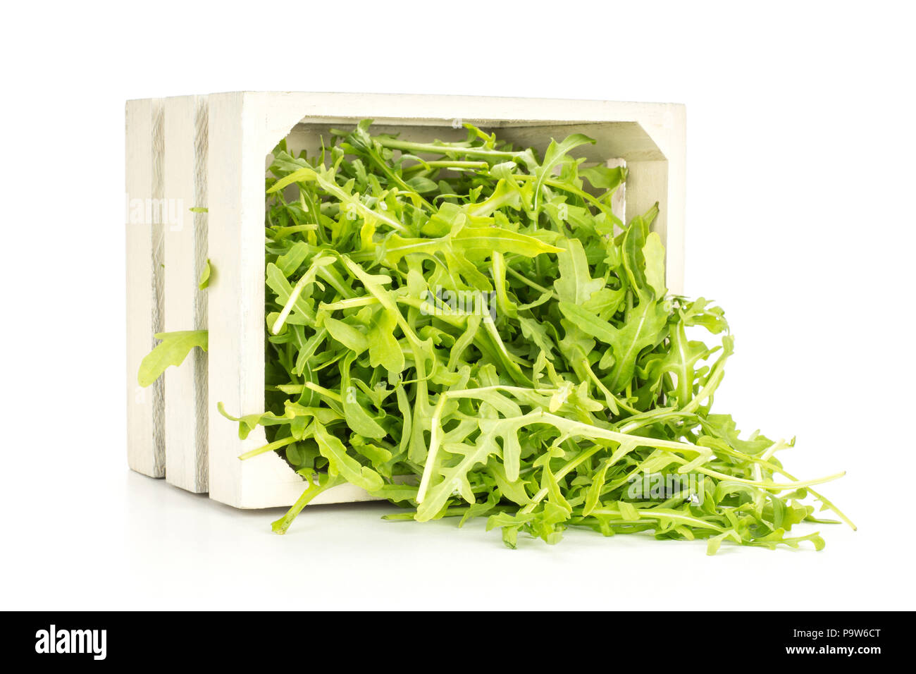 Fresh arugula out a wooden box isolated on white background green ...