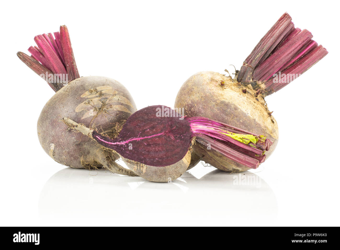 Two red beet and one half young bulbs isolated on white background cut ...