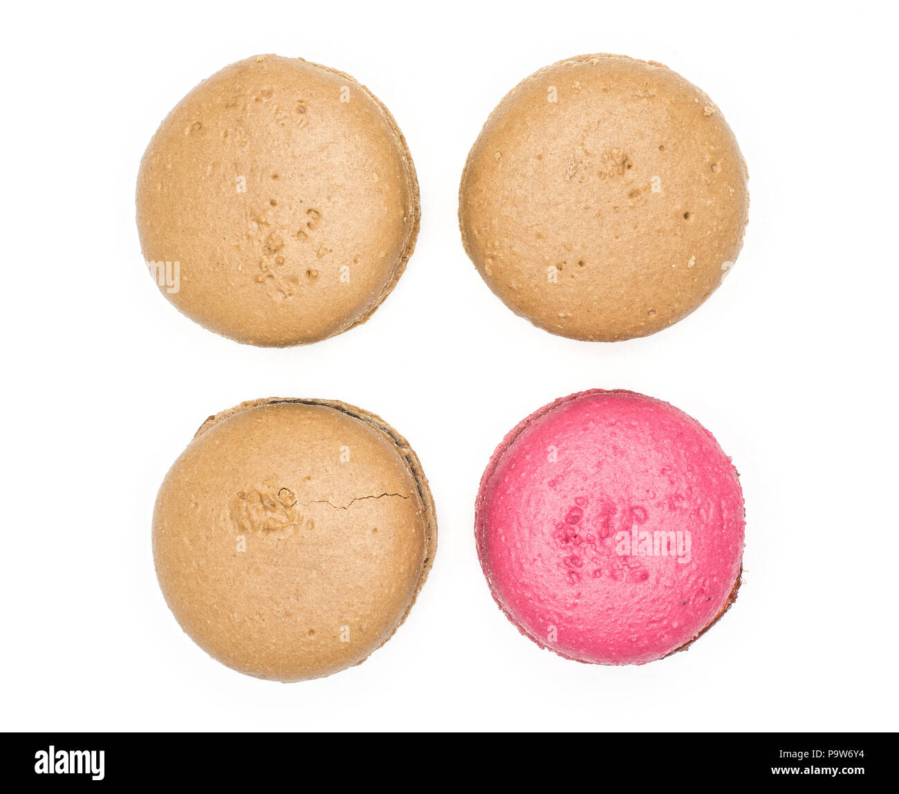 Four French macarons three with chocolate and one with raspberry top ...