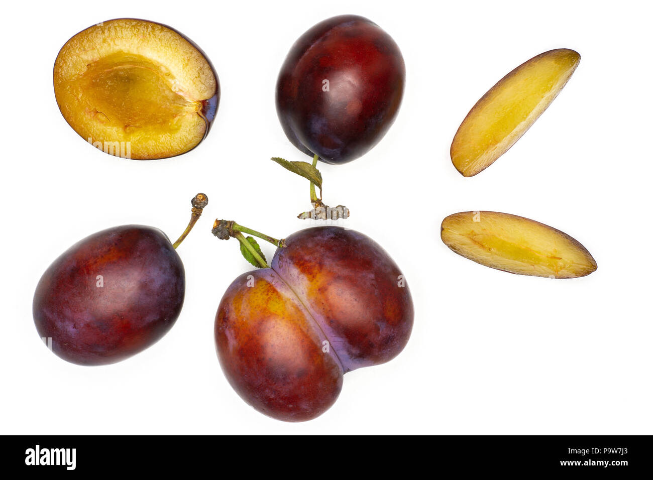 Group of three whole one half two slices of fresh violet-blue plum ...