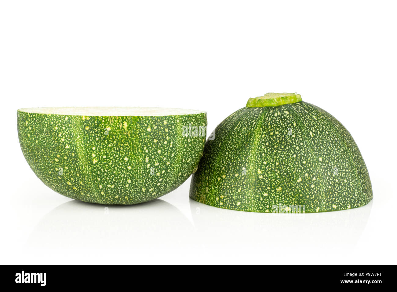 Sliced round zucchini two cut halves isolated on white background fresh ...